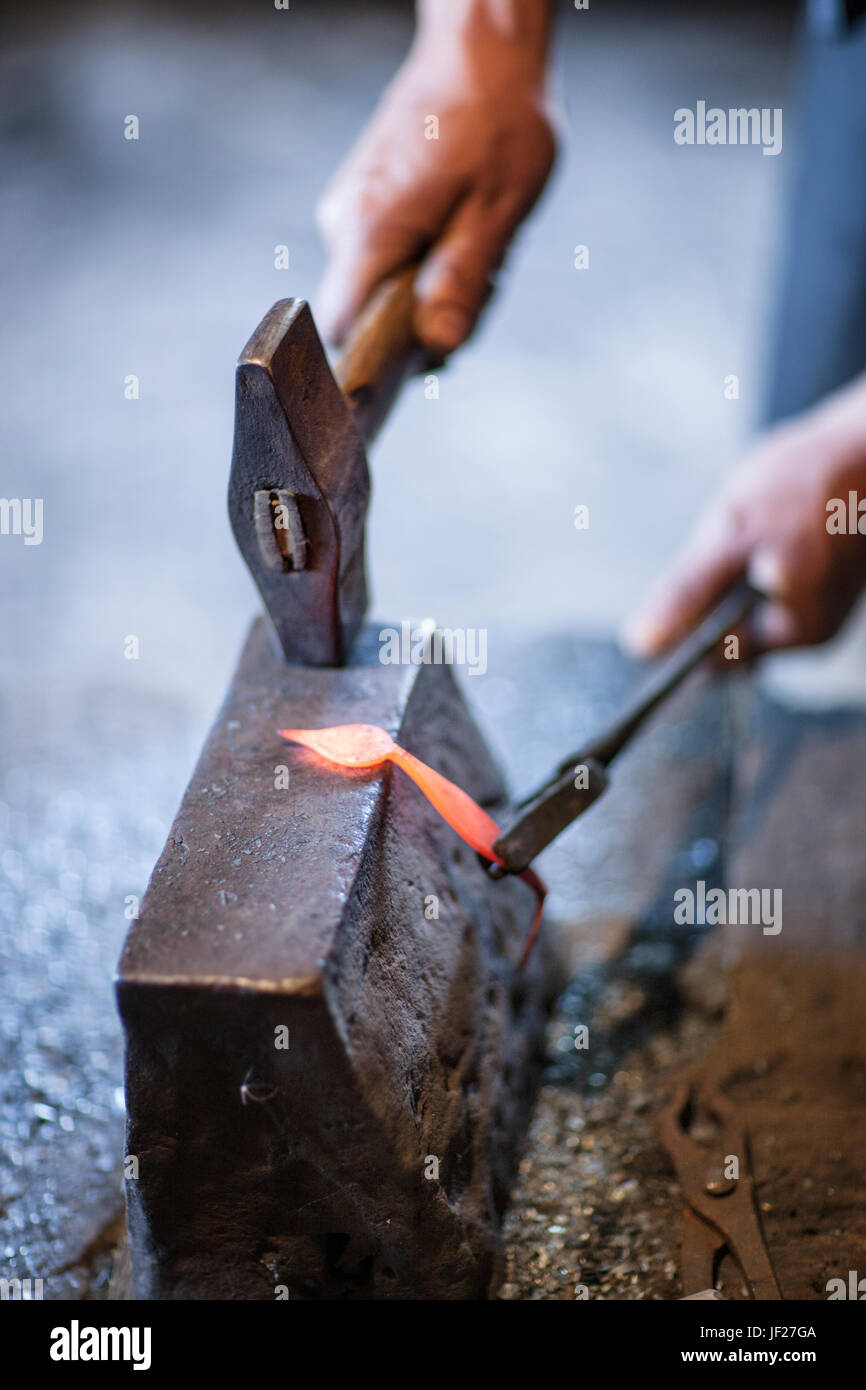 Close-up of hand bending molten rod Stock Photo - Alamy