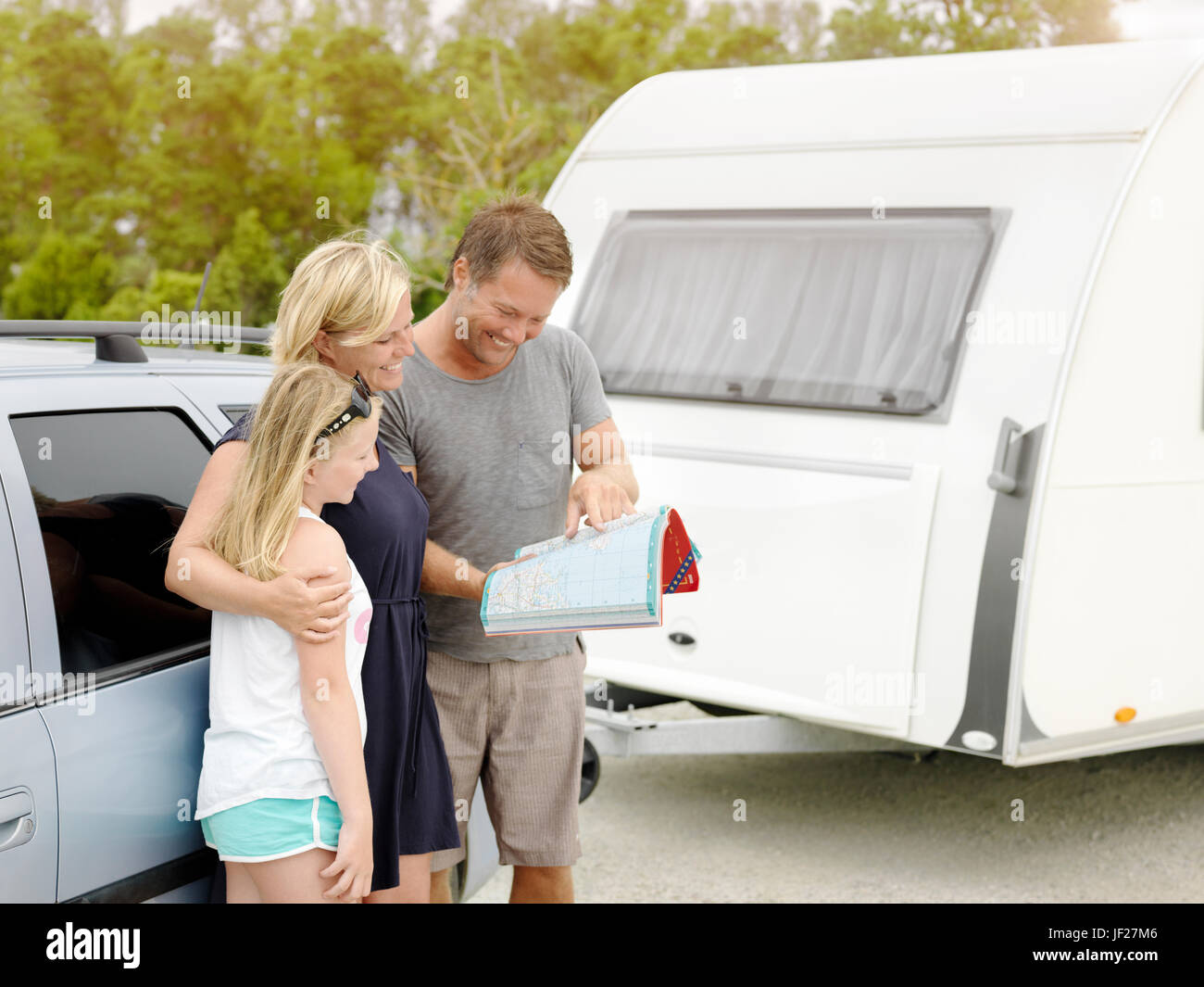 Family reading map Stock Photo - Alamy