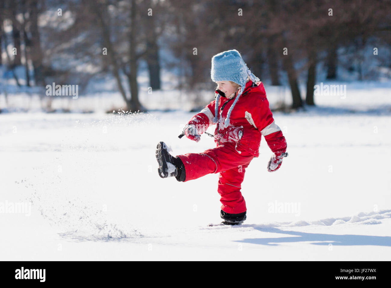 Girl kicking snow Stock Photo - Alamy