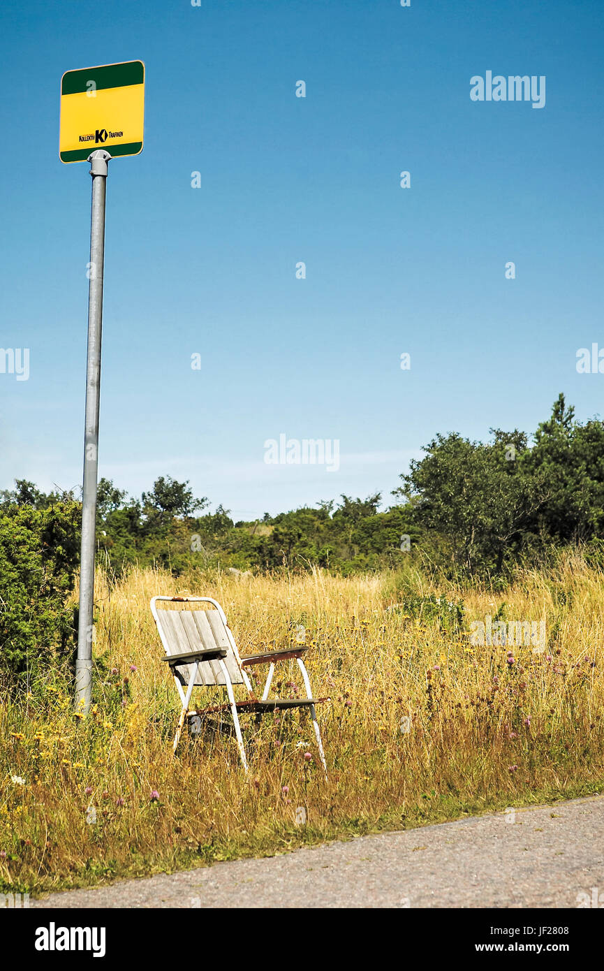 Wooden chair at bus stop Stock Photo - Alamy