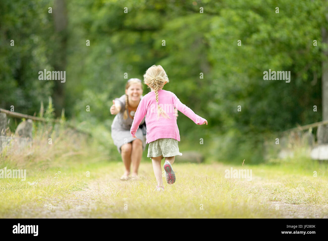 Woman and child running away hi-res stock photography and images - Alamy