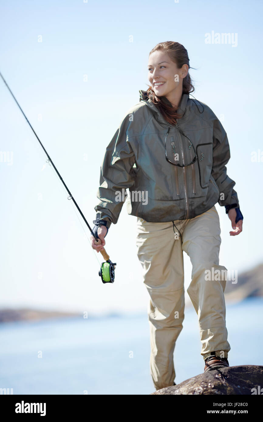 Woman with fishing rod Stock Photo - Alamy