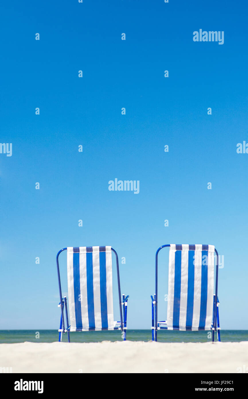 Sun chairs on beach Stock Photo - Alamy