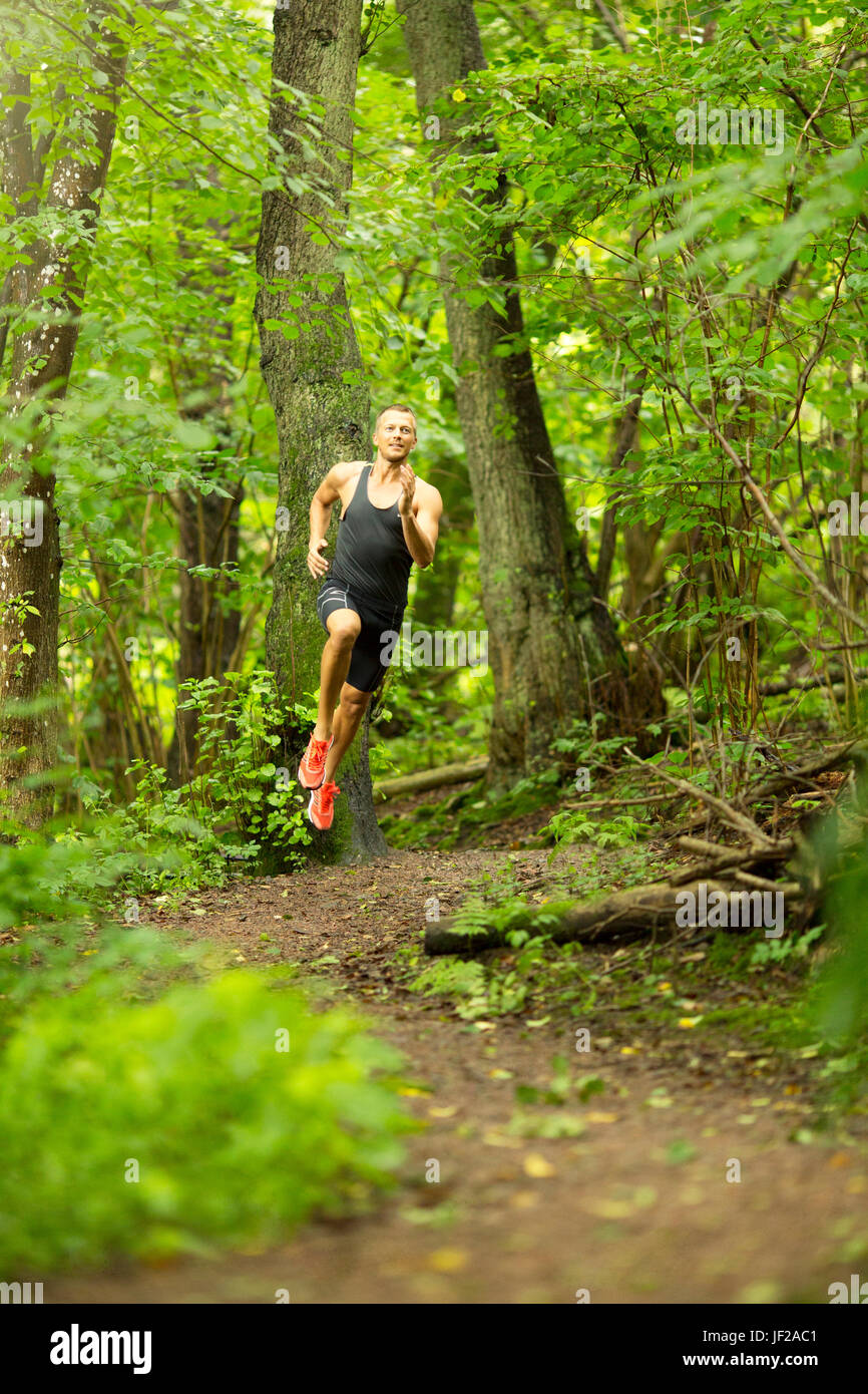 Man running in forest Stock Photo - Alamy