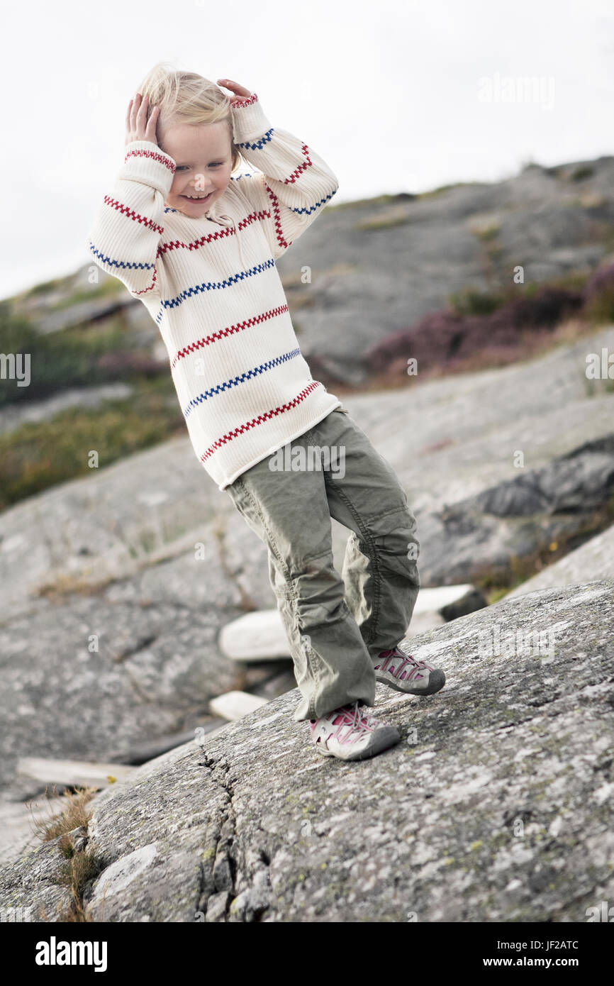 Smiling girl on rocks Stock Photo - Alamy