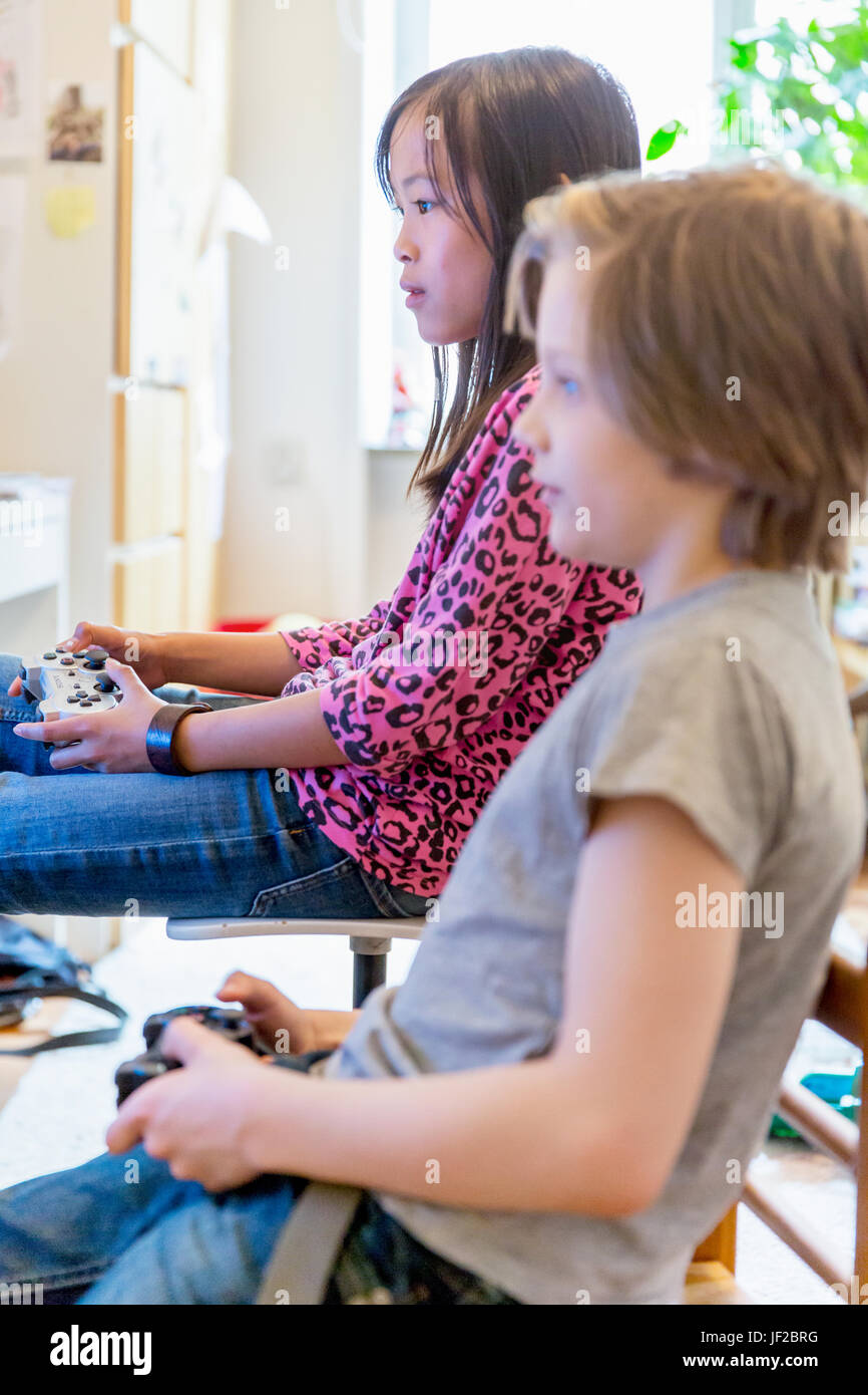 Boy and girl playing video game Stock Photo - Alamy