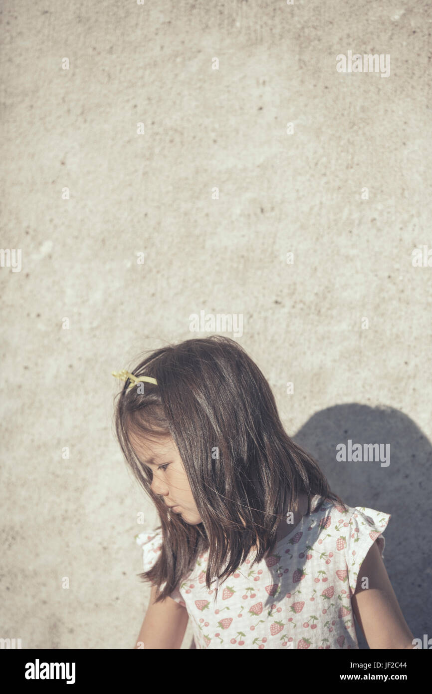 Girl against wall Stock Photo - Alamy