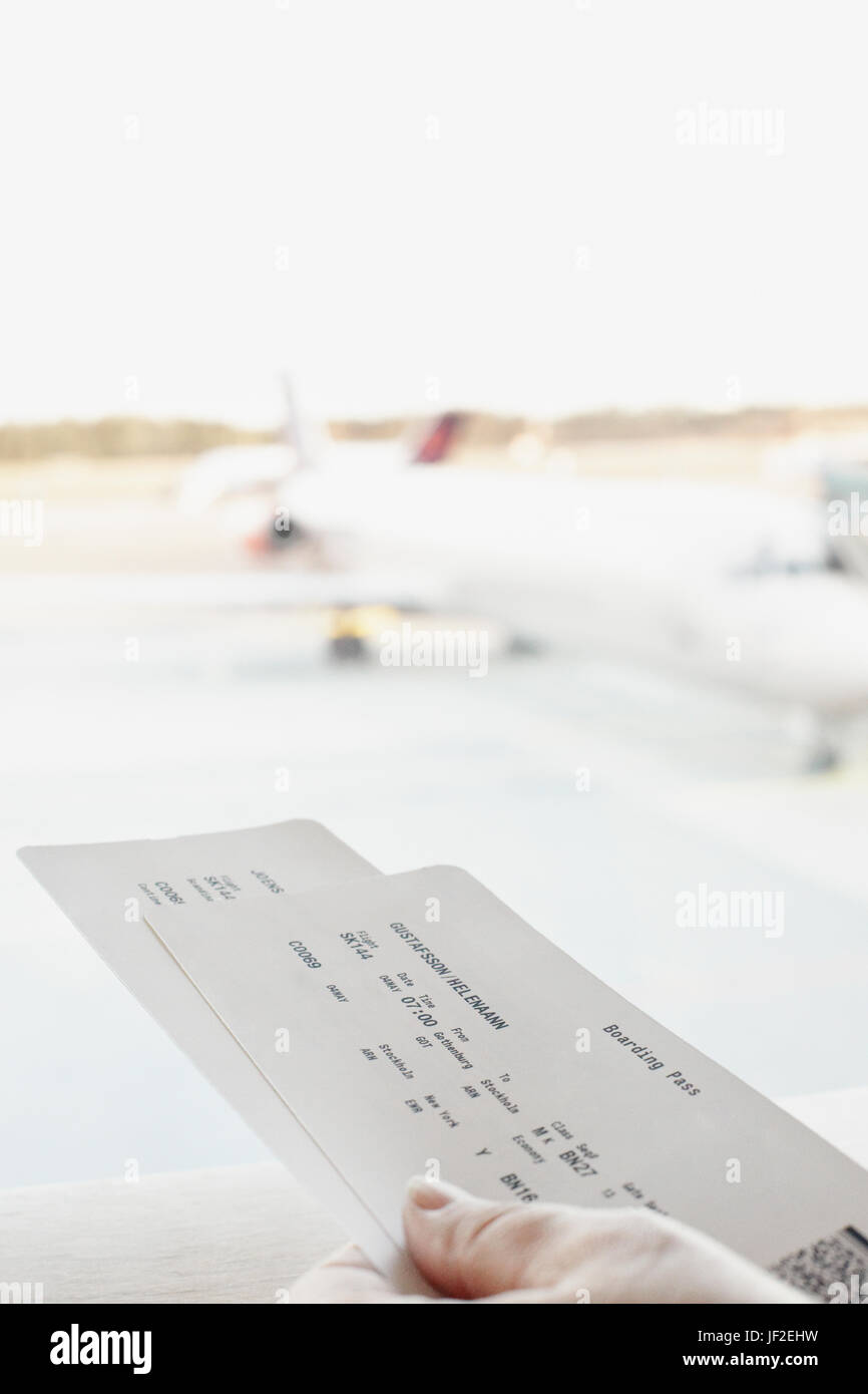 Hand holding boarding pass Stock Photo - Alamy