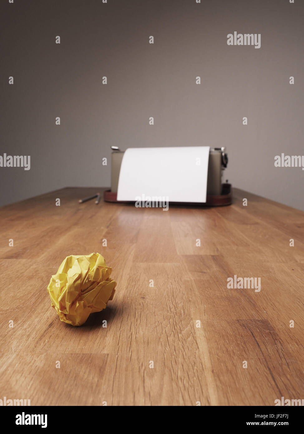 Crumpled paper with an old typewriter on a wooden office desk ...