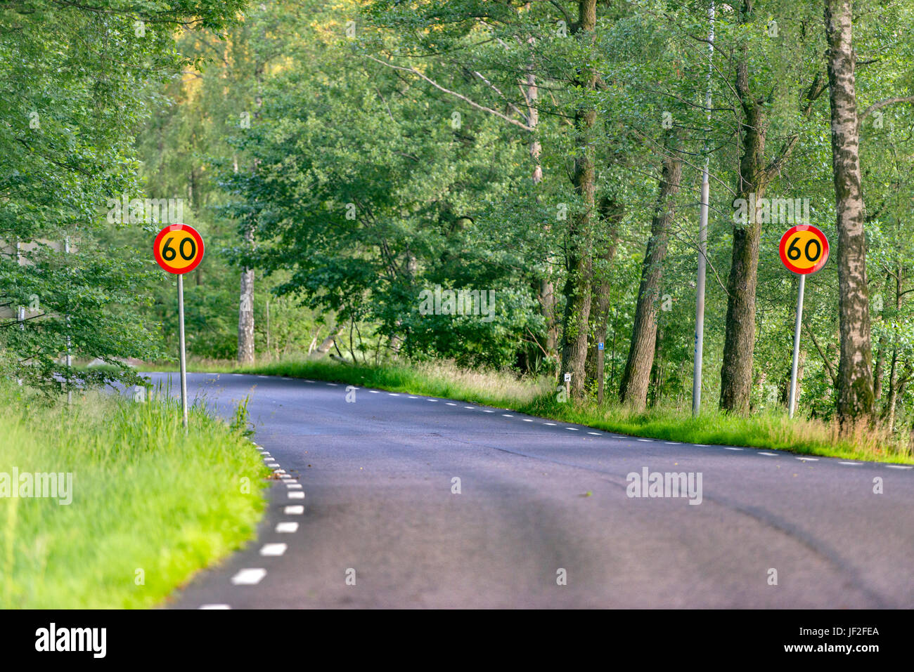 Country road with speed limit sign Stock Photo - Alamy
