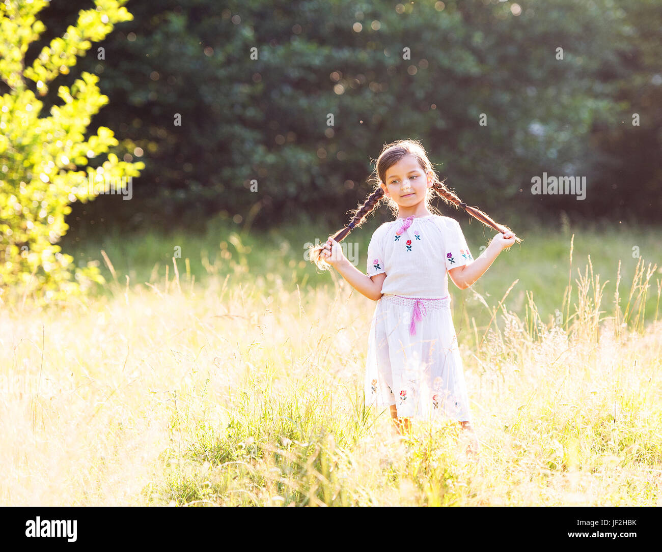 little happy girl with tight braids wearing traditional romanian blouse ...