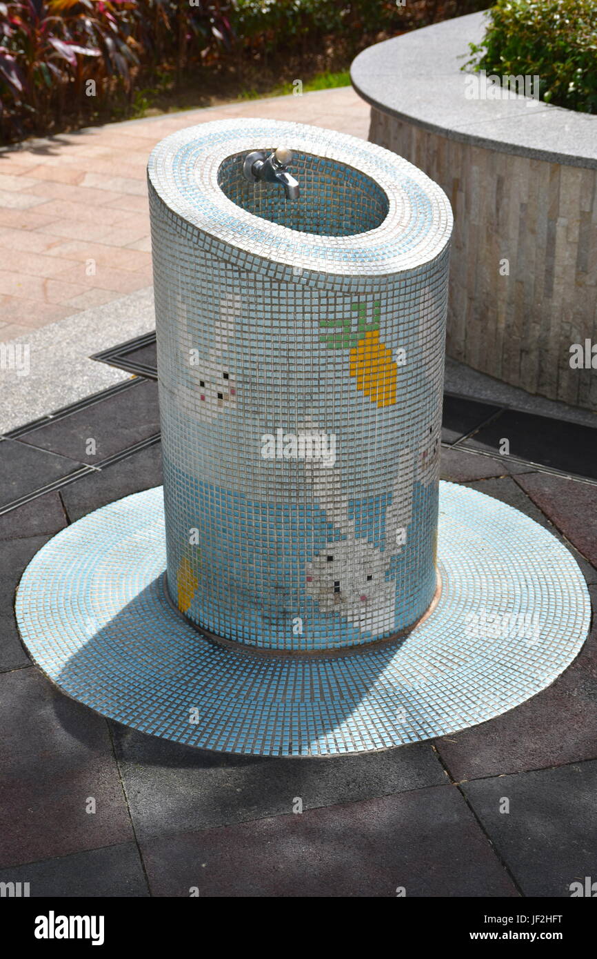A cute tile water fountain for drinking from with white rabbits and ...