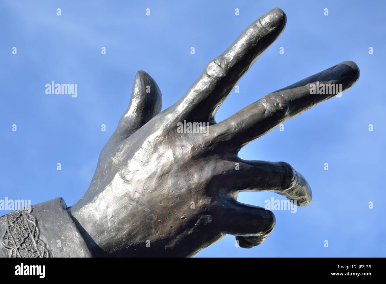 Bronze hand reaching Stock Photo - Alamy