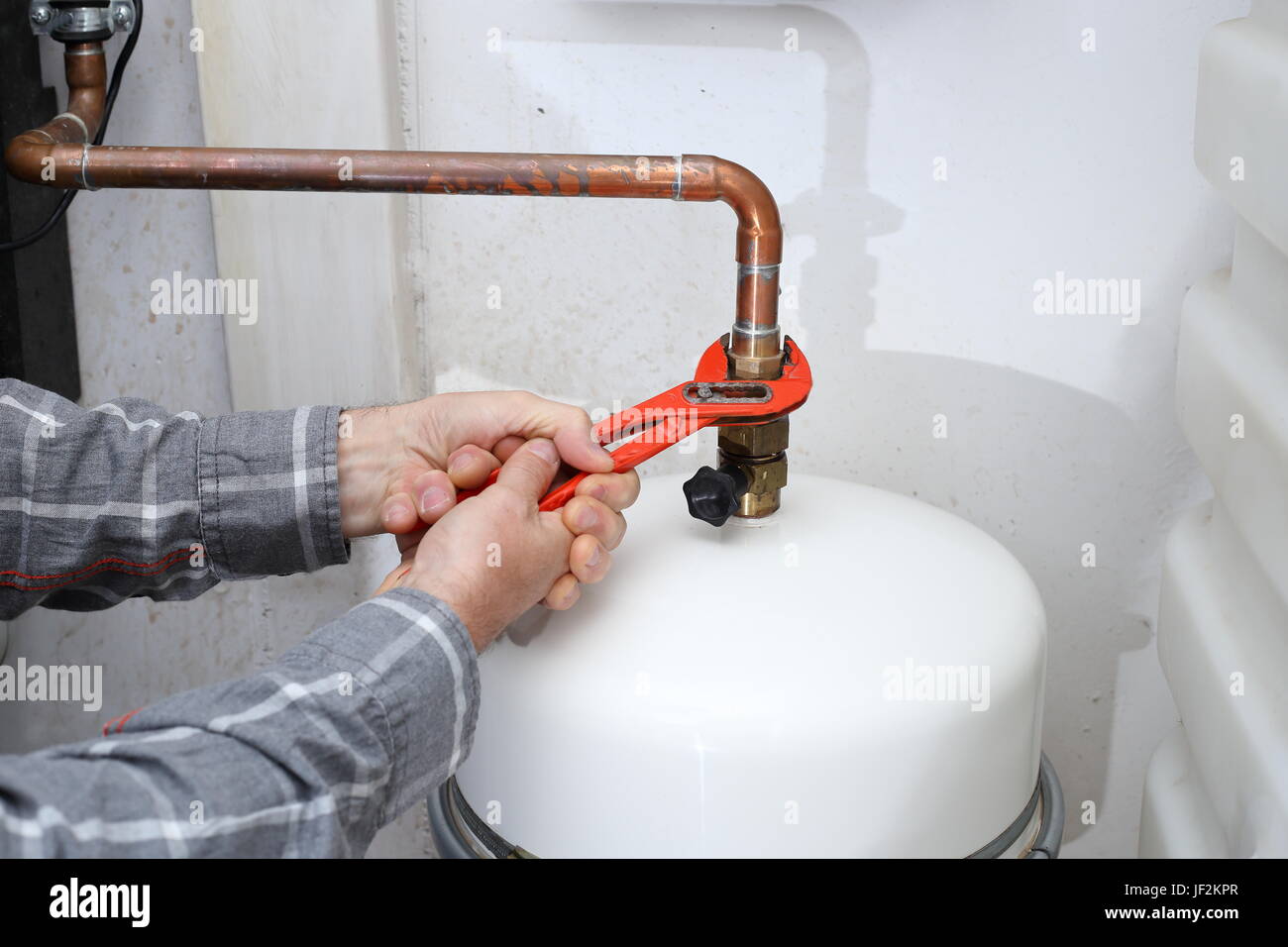 worker is fixing a pipe Stock Photo - Alamy