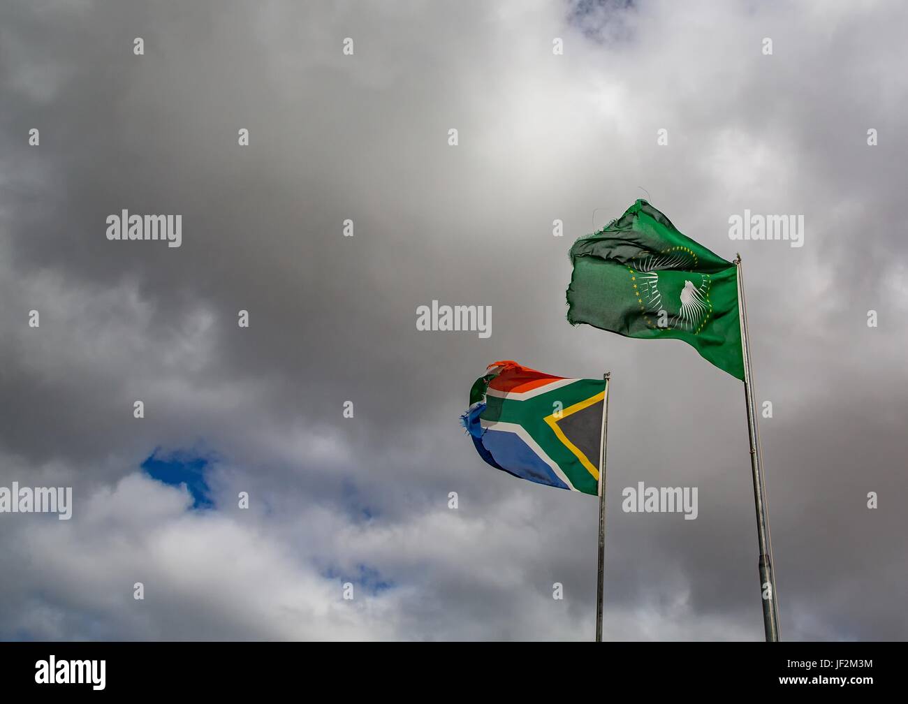 Waving flags of South Africa and the African Union in front of cloudy ...