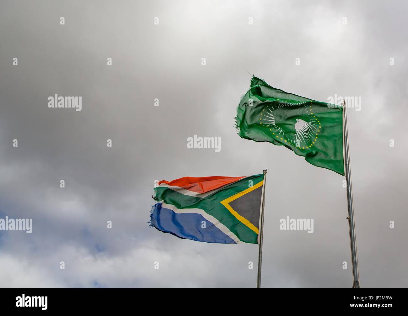 Waving flags of South Africa and the African Union in front of cloudy ...