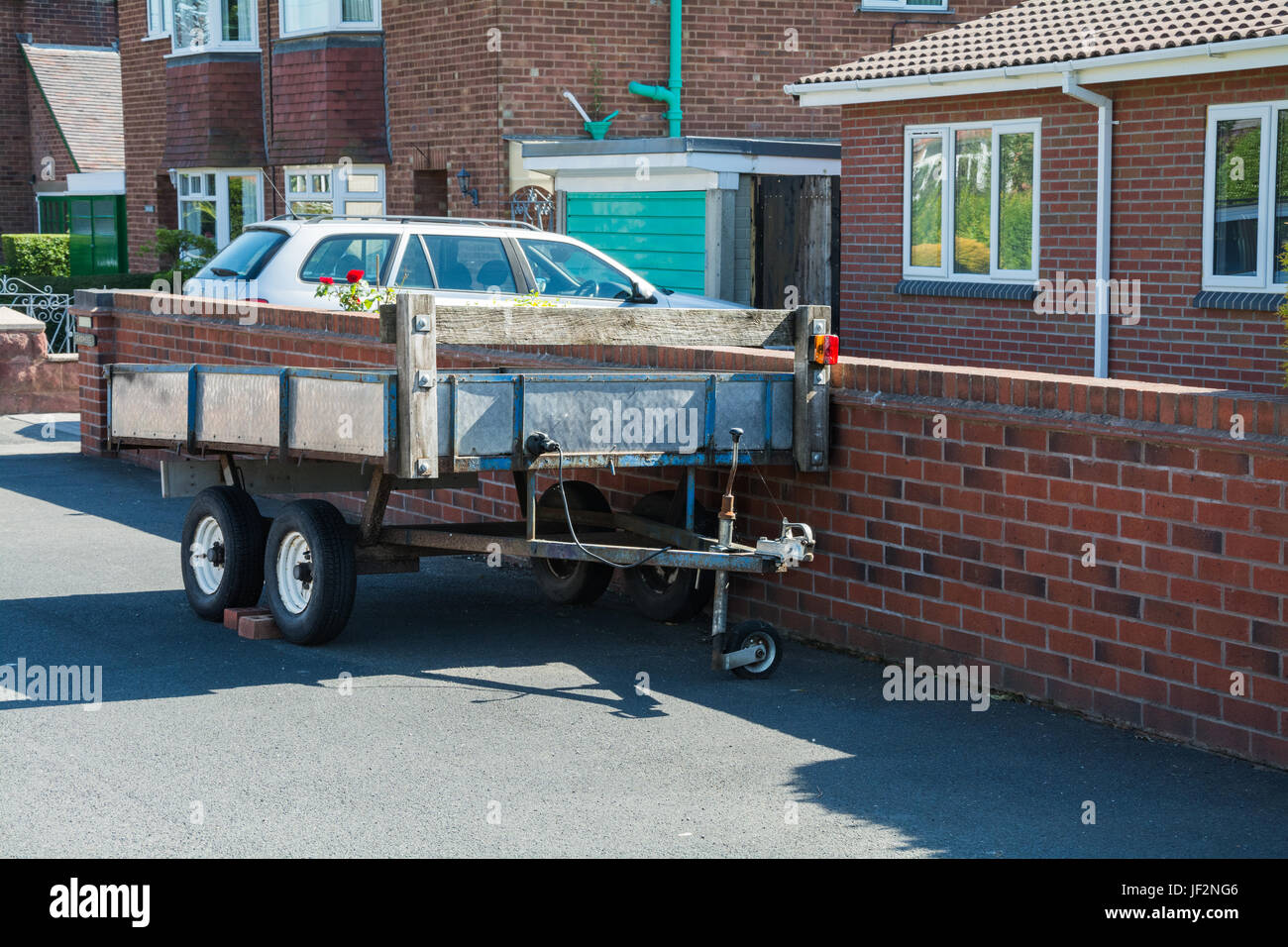 A trailer parked outside a bungalow in the UK Stock Photo - Alamy