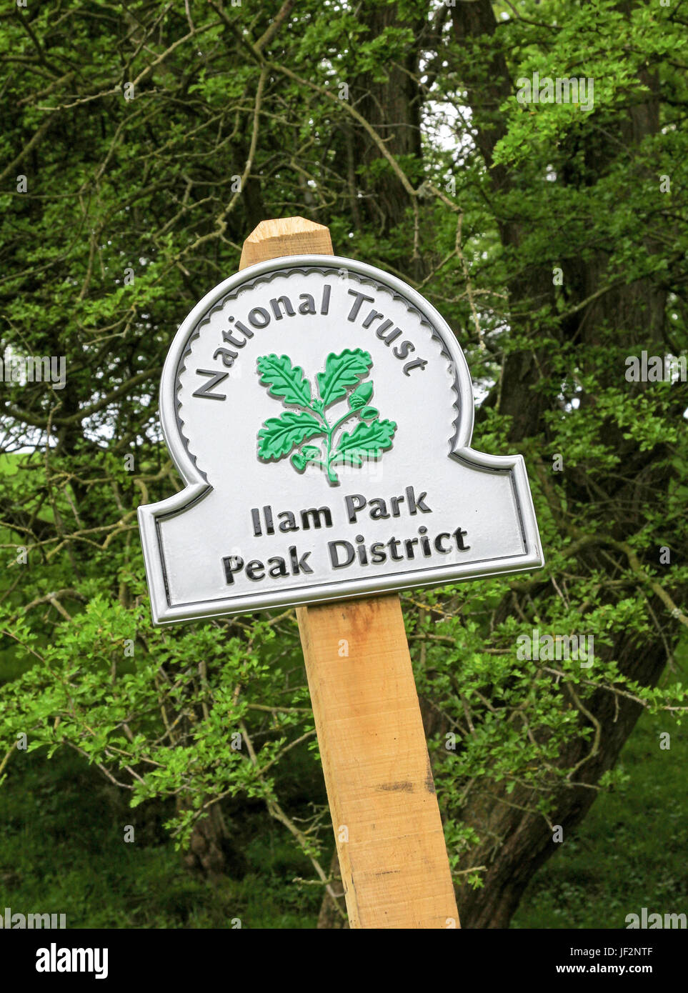 A National Trust 'omega' sign on a public footpath through Ilam Park ...