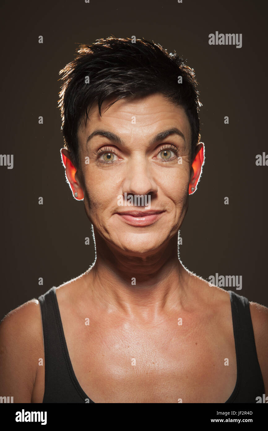 Smiling woman in the back light on black Stock Photo - Alamy