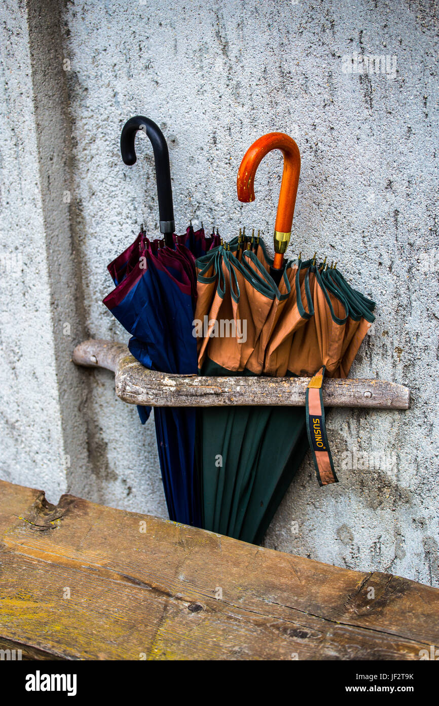 Two umbrellas in space for umbrellas on a grey house's wall Stock Photo ...