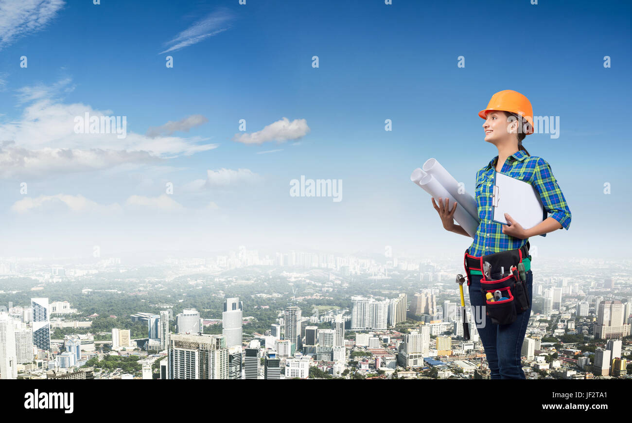 Engineer woman with blueprint on modern city landscape Stock Photo - Alamy
