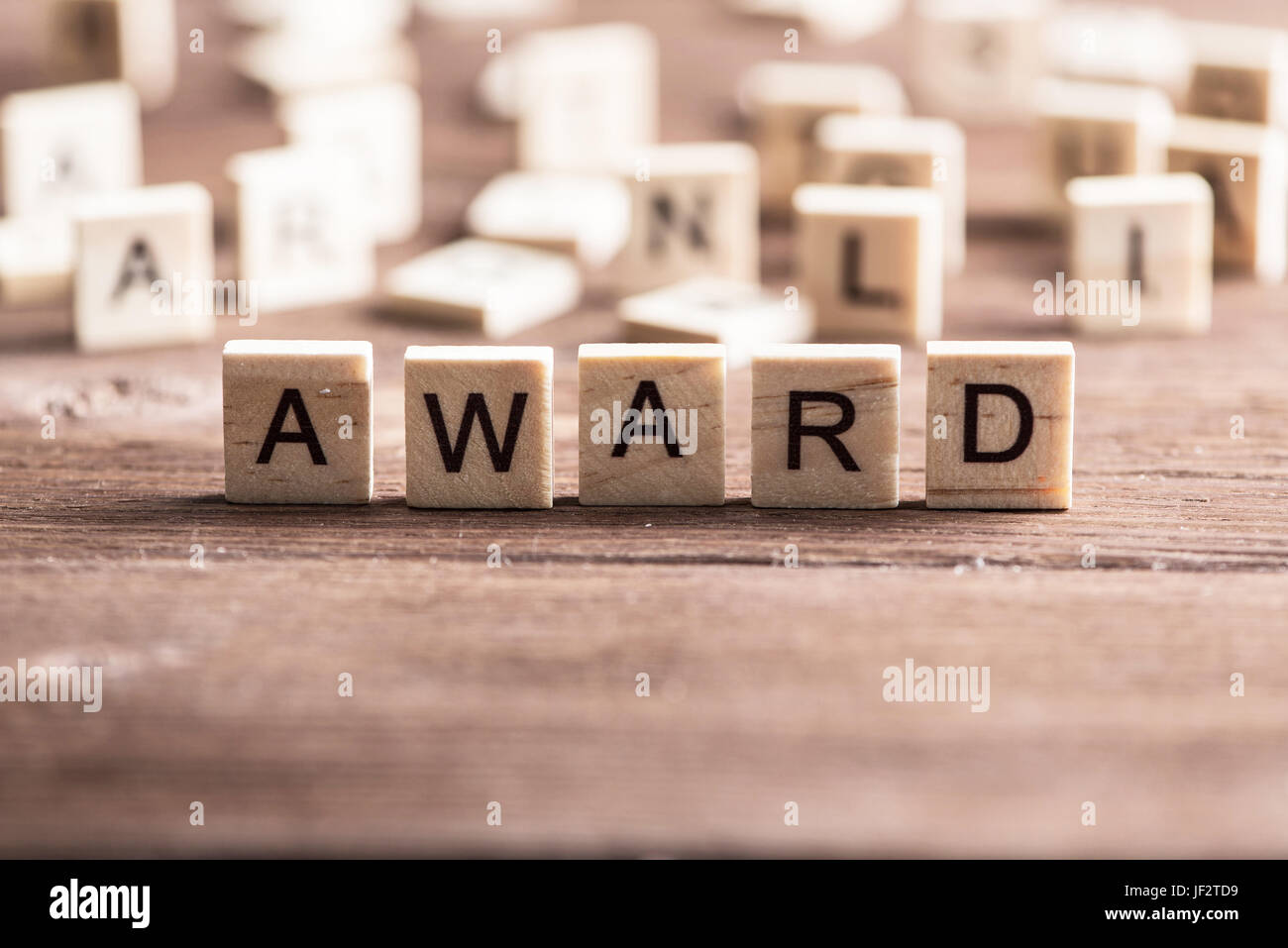 Wooden elements on wooden table spelling word award Stock Photo - Alamy