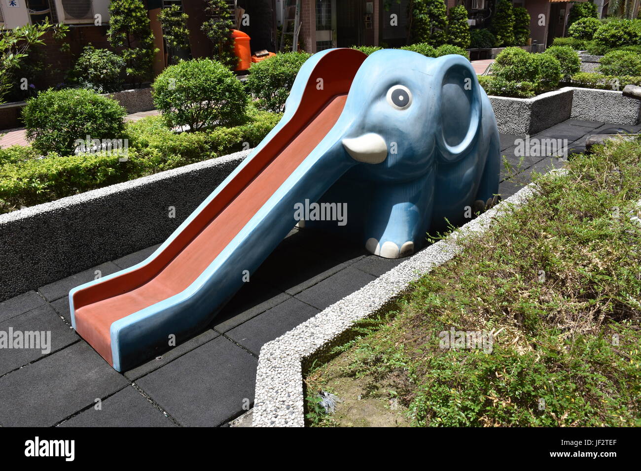A fun blue elephant with white tusks and a long trunk that is the slide ...