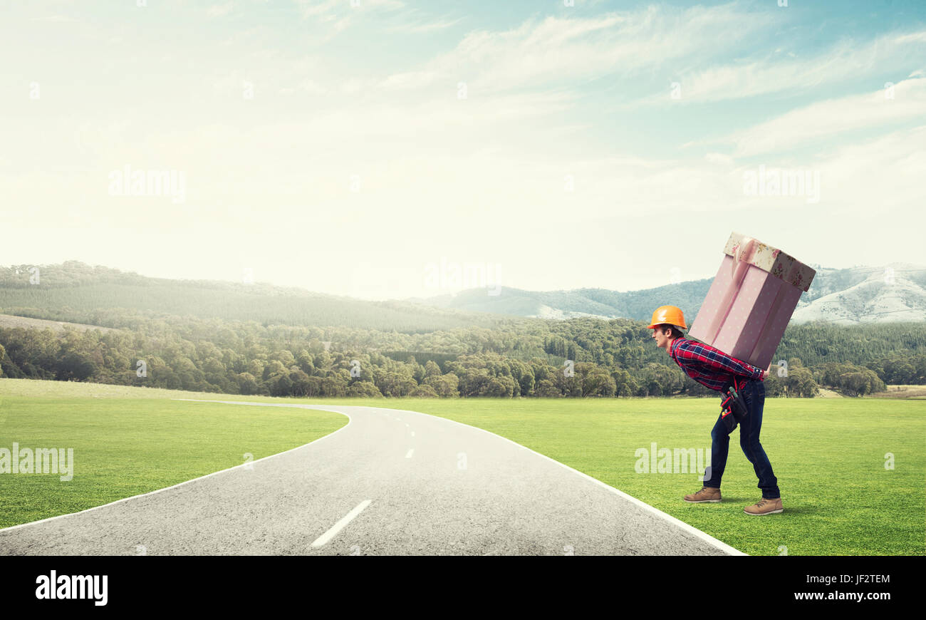 Man carrying on his back large box Stock Photo - Alamy
