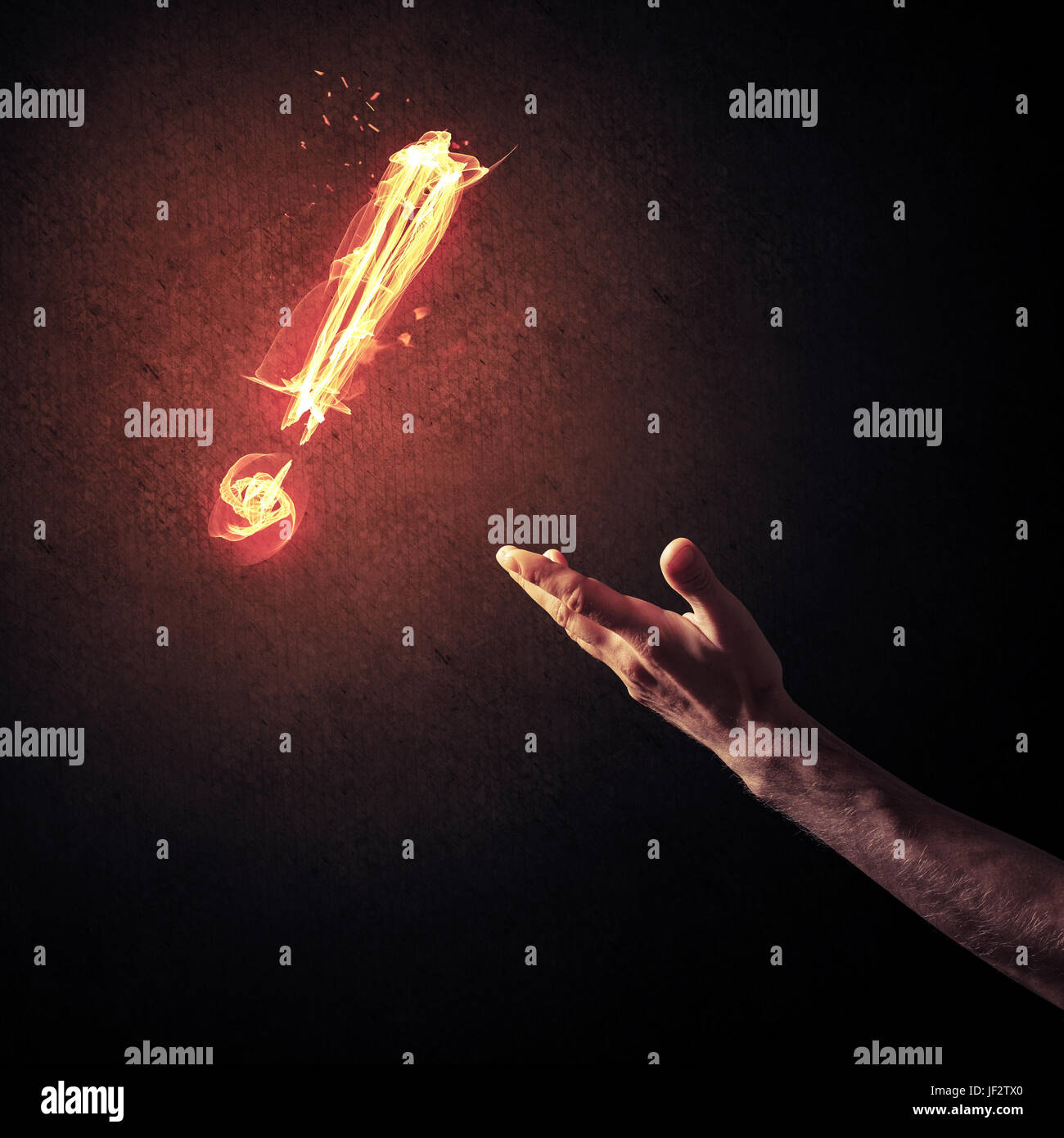 Hands reaching each other and fire glowing exclamation mark Stock Photo ...