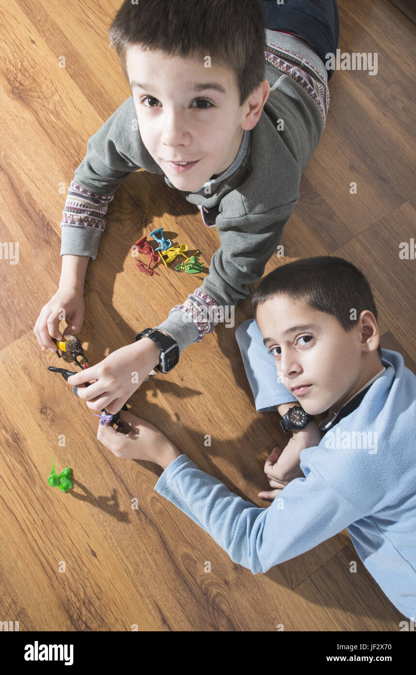 Childs playing with small toys Stock Photo - Alamy