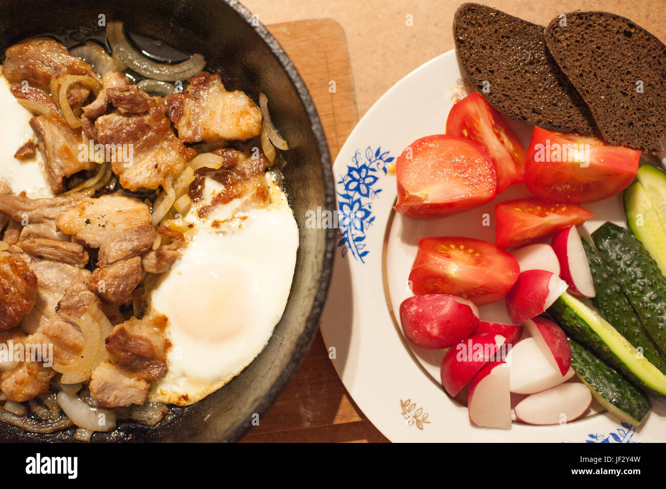 Rich rustic breakfast. Rural food, fried egg pork and fresh vegetables ...