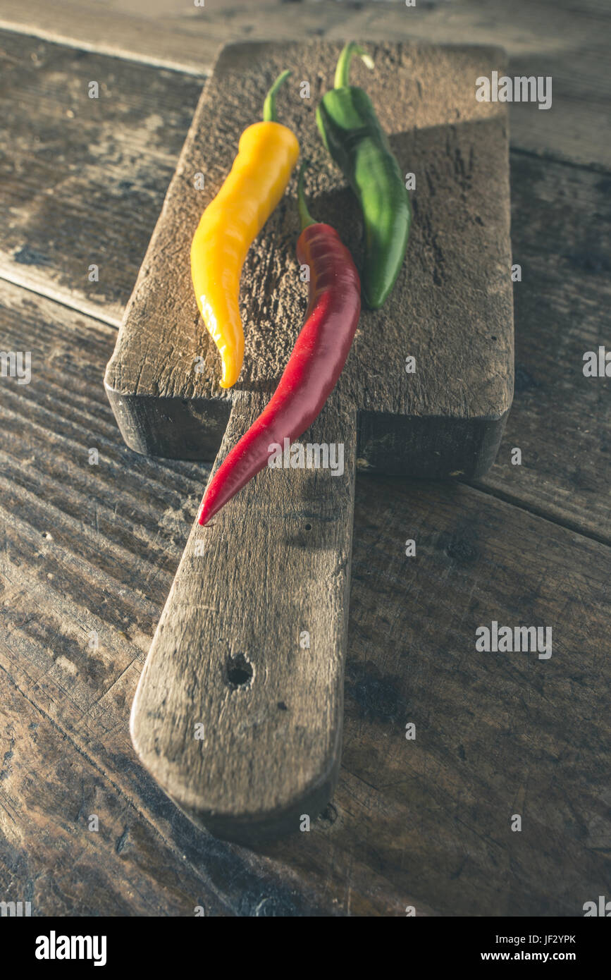 Hot peppers on wooden cutting board Stock Photo - Alamy