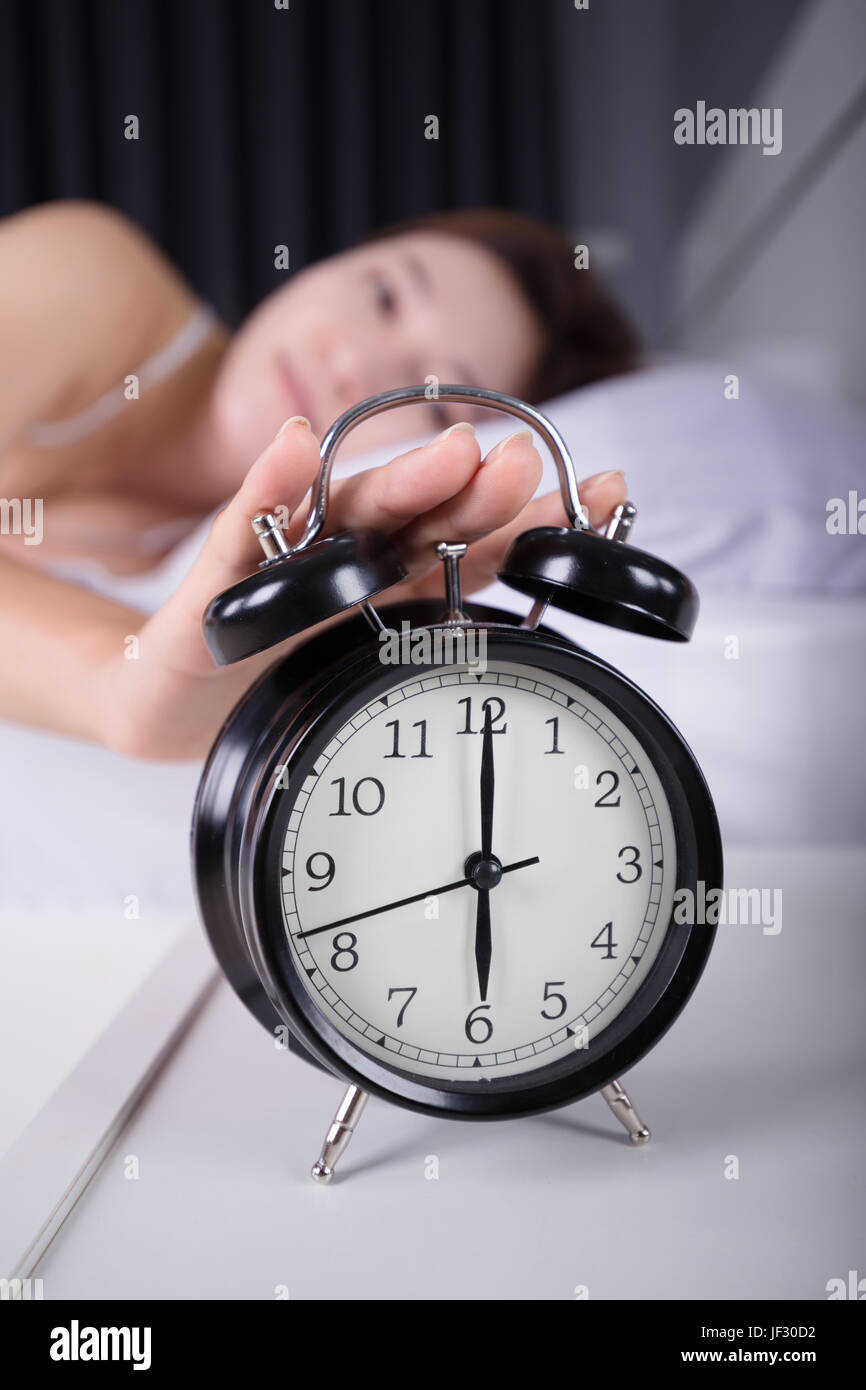 Woman Sleeping And Wake Up To Turn Off The Alarm Clock In The Morning