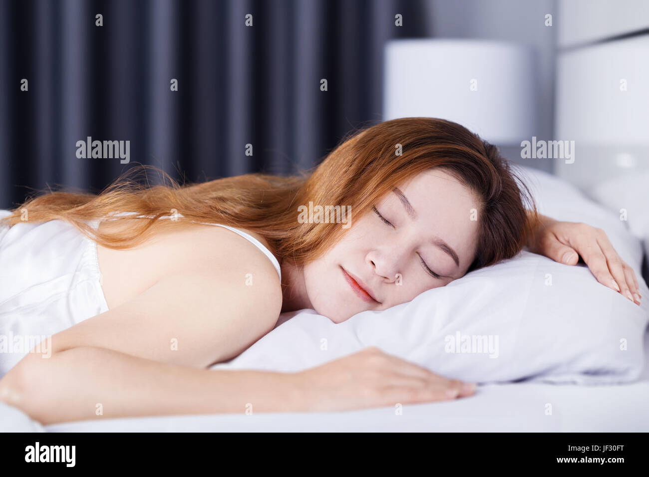 Woman sleeping on bed in the bedroom Stock Photo - Alamy
