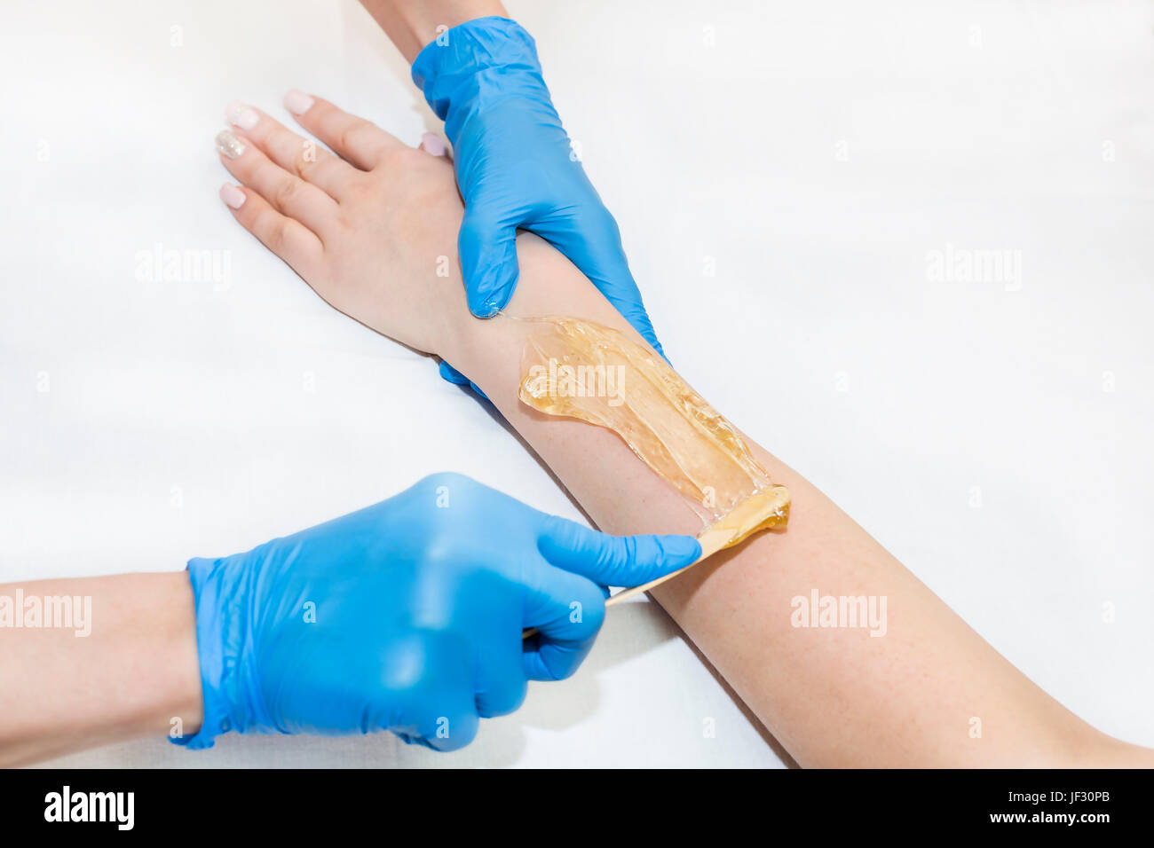 Depilation sugar processes woman passes in a beauty salon Stock Photo ...