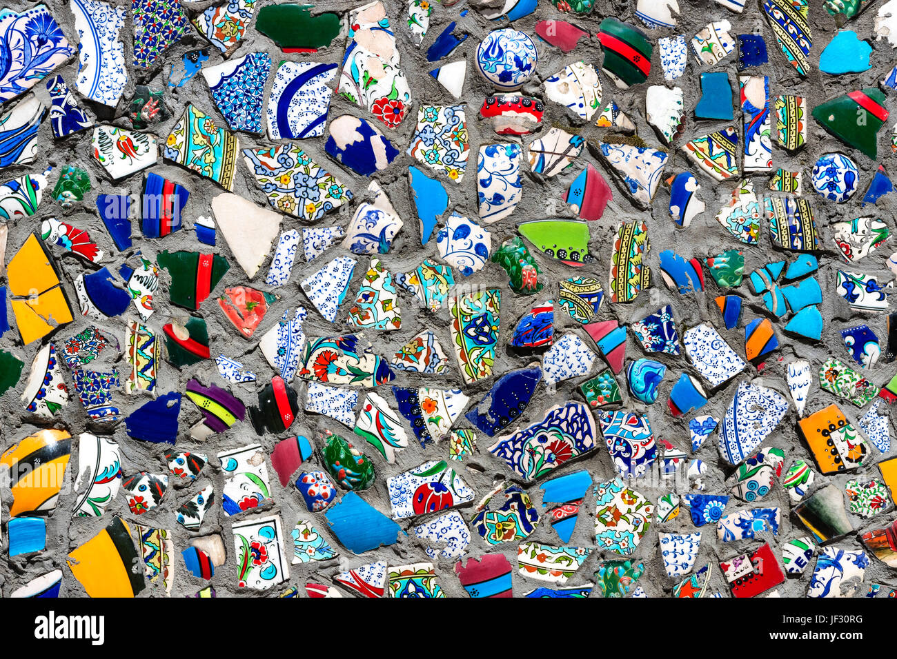 Wall with broken ceramic plates colored fragments Stock Photo - Alamy