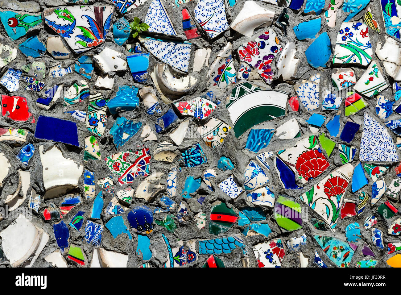 Wall with broken ceramic plates colored fragments Stock Photo - Alamy
