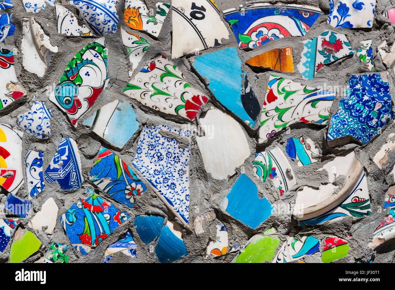 Wall with broken ceramic plates colored fragments Stock Photo - Alamy