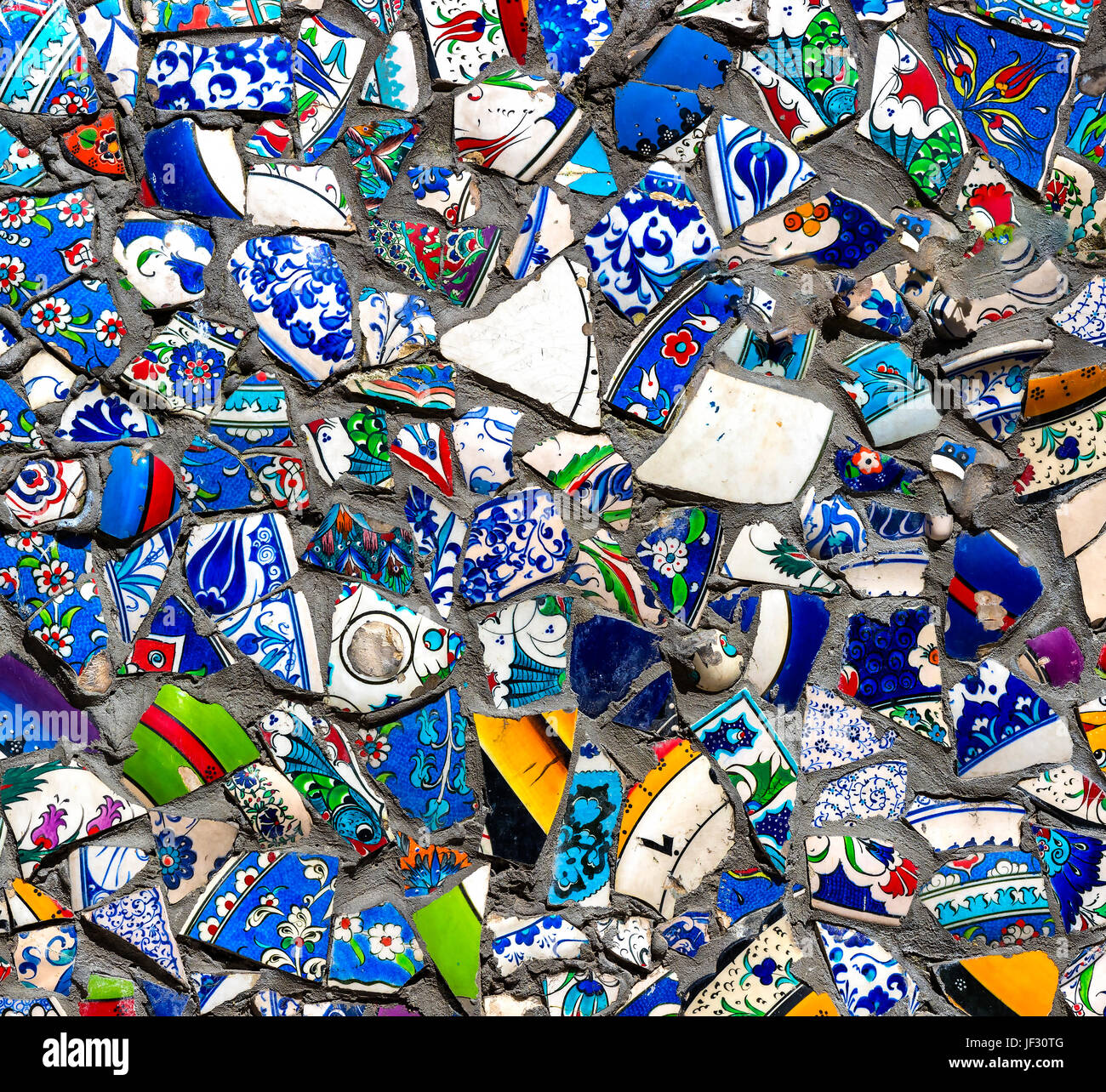 Wall with broken ceramic plates colored fragments Stock Photo - Alamy