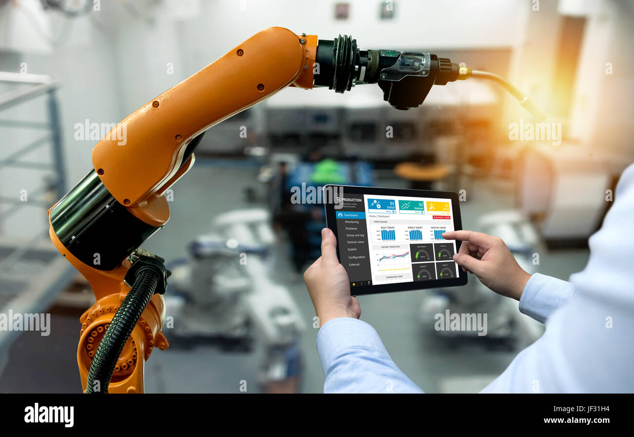 Engineer hand using tablet, heavy automation robot arm machine in smart ...