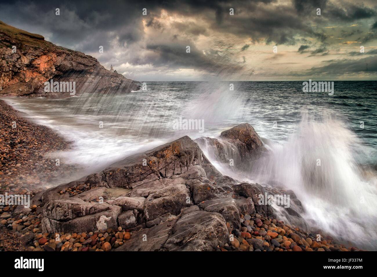 Crashing waves and storm clouds Stock Photo - Alamy