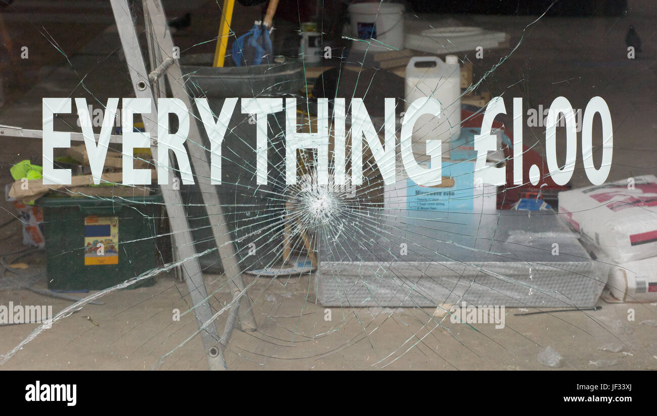 Broken glass front window at of shop undergoing refurbishment with ...