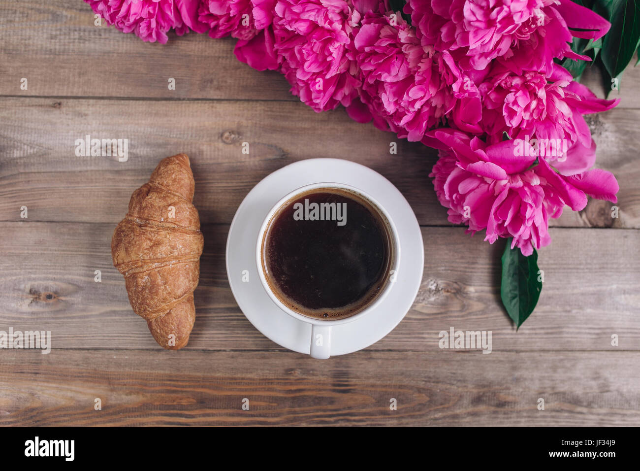 A cup of coffee , pink peonies pattern and gift box on wooden ...