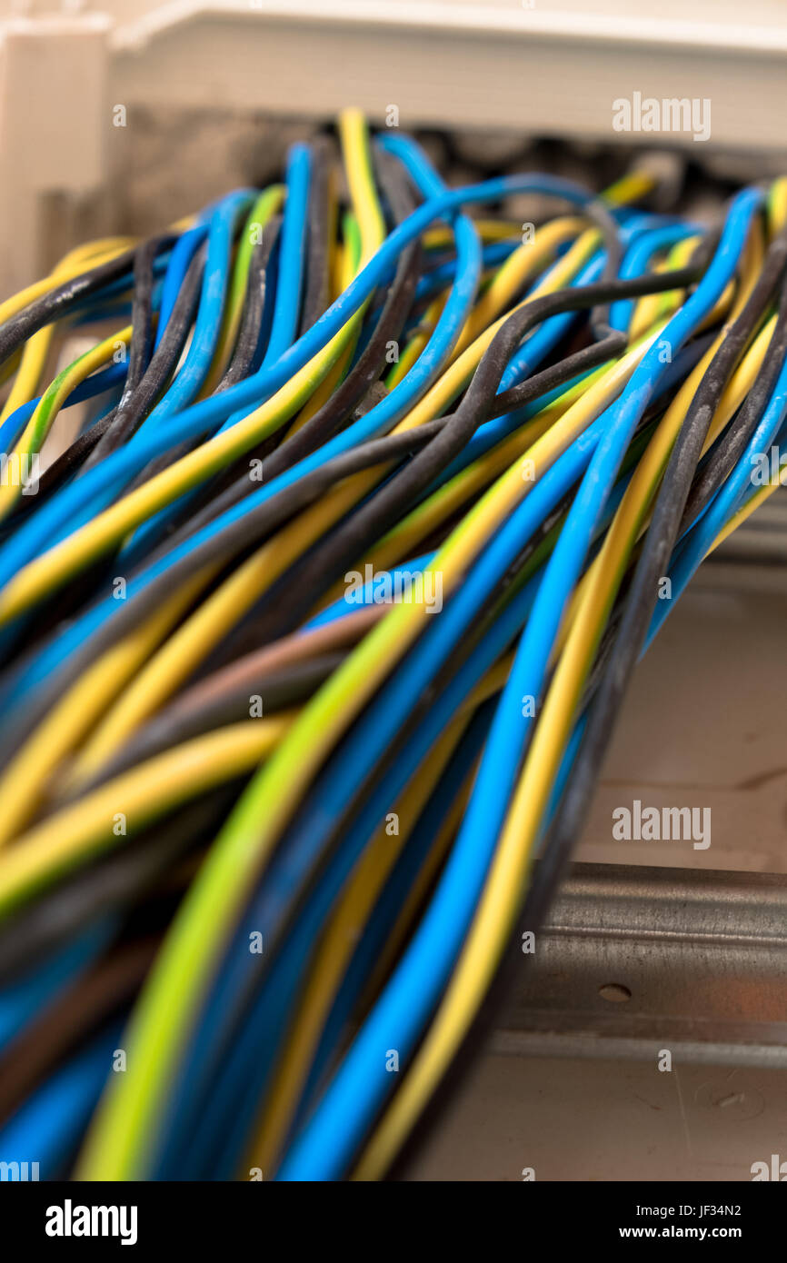Multiple colors cable wires leading from the wall under construction ...