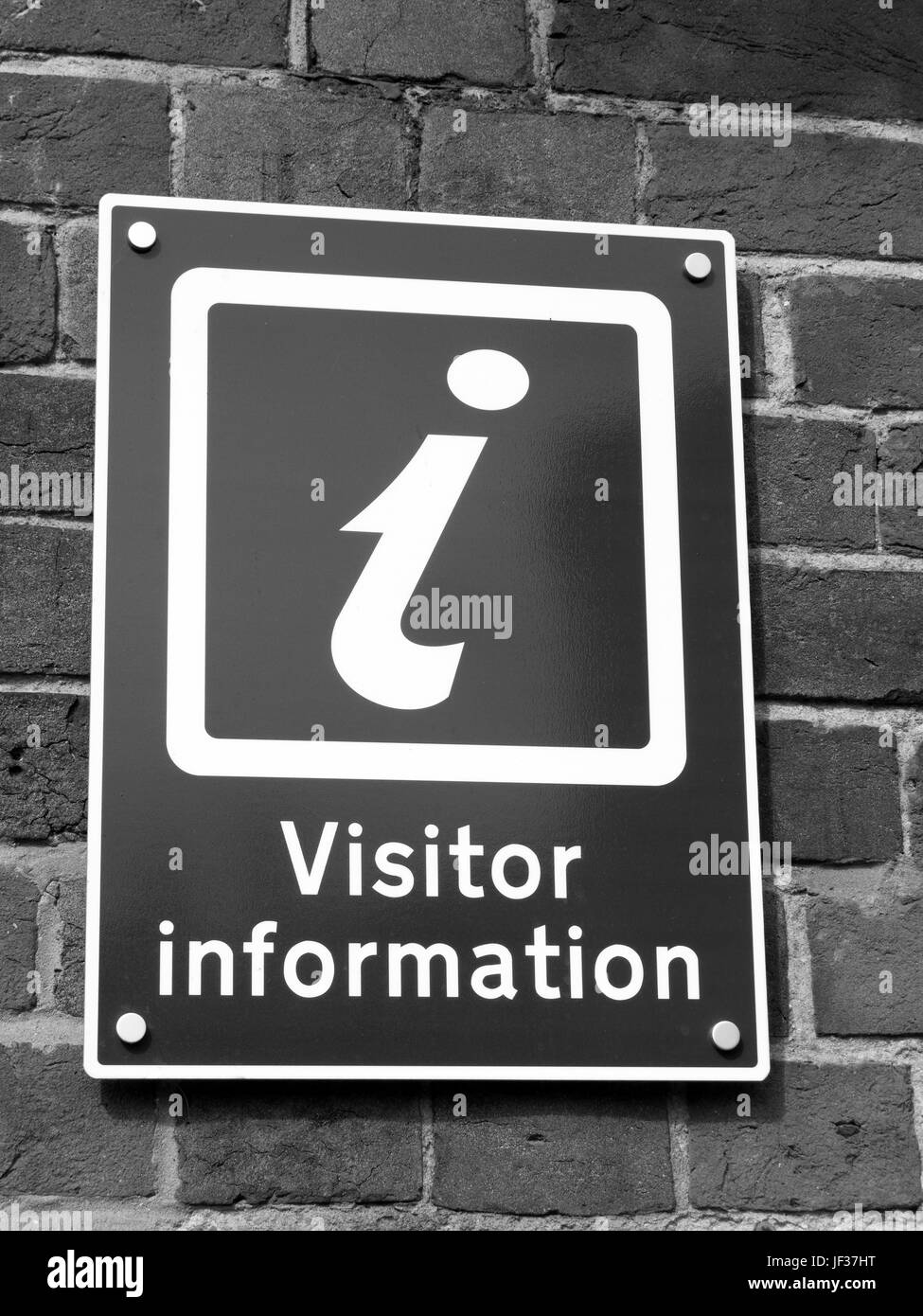 Visitor Information sign mounted on brick wall Stock Photo - Alamy