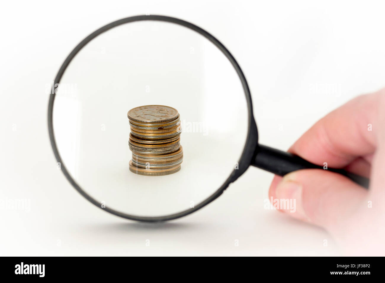 Coins through a magnifying glass closeup on a white background Stock ...