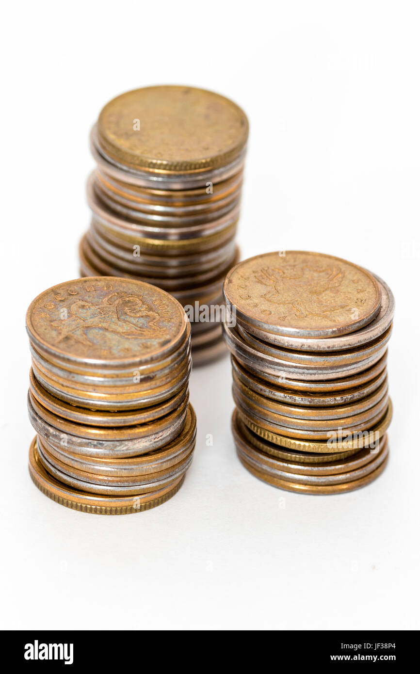 Three stacks of coins close up on white background Stock Photo - Alamy