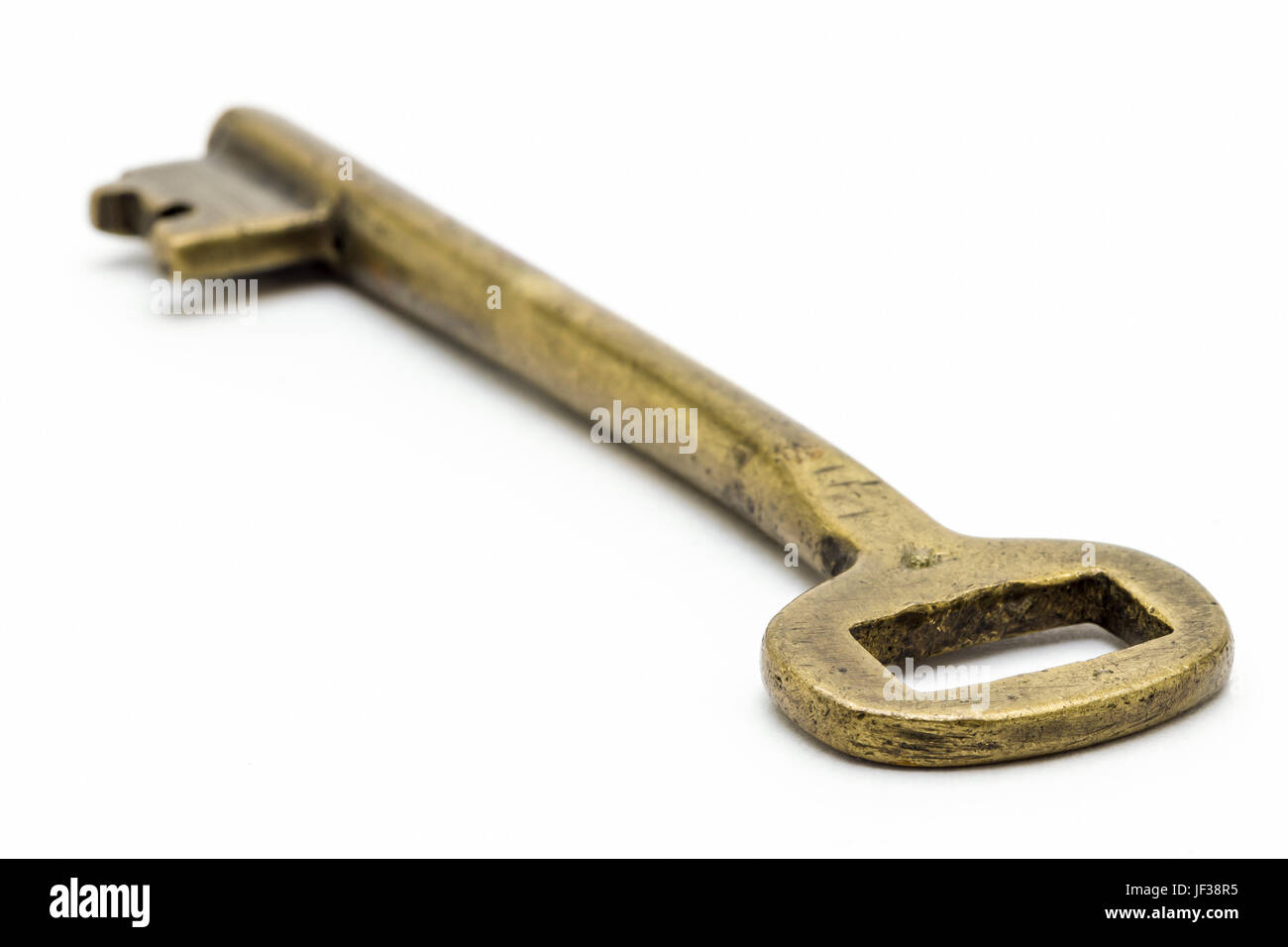Old brass door key close-up on a white background Stock Photo - Alamy