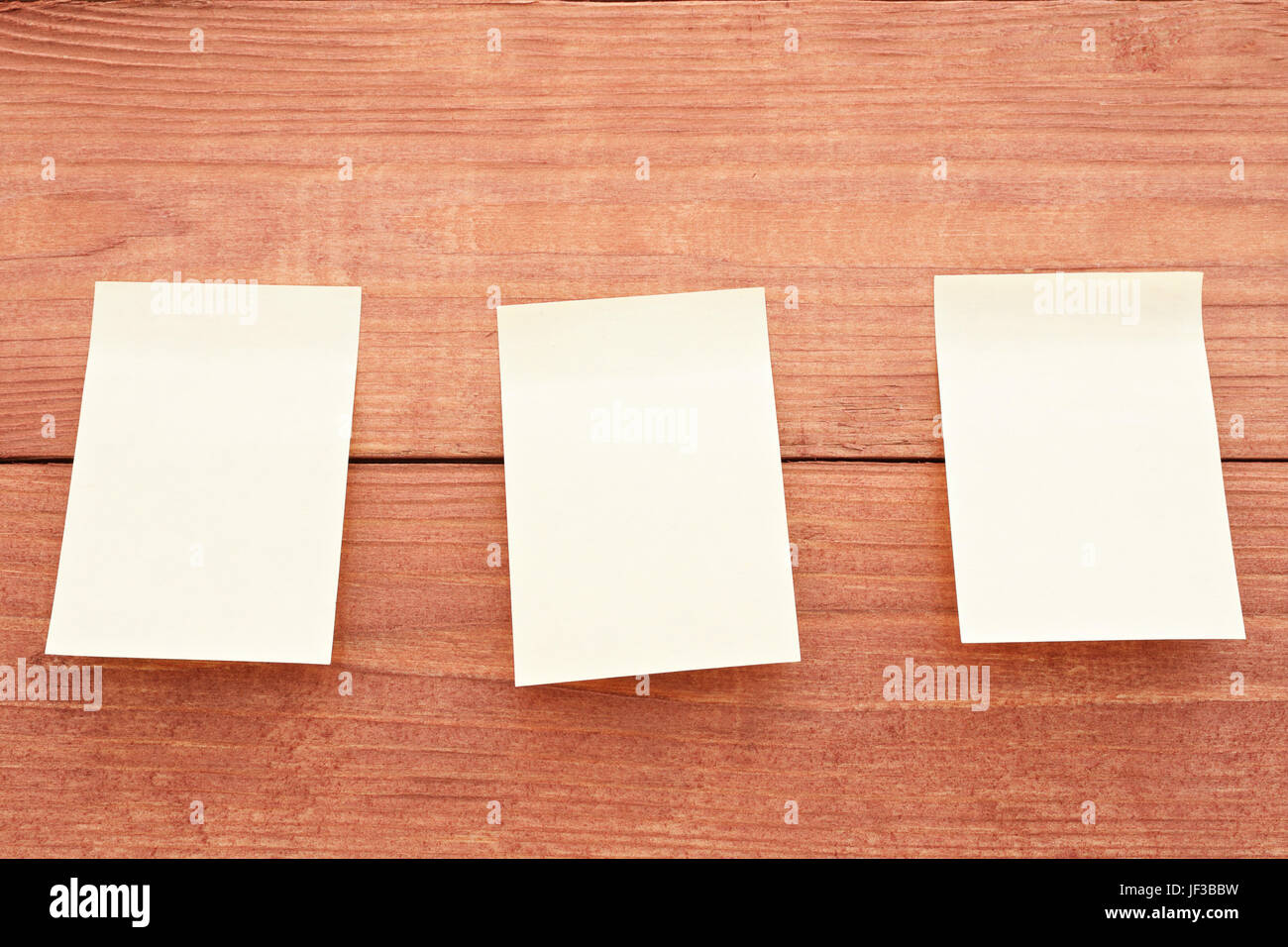 Three stickers on wood background Stock Photo - Alamy