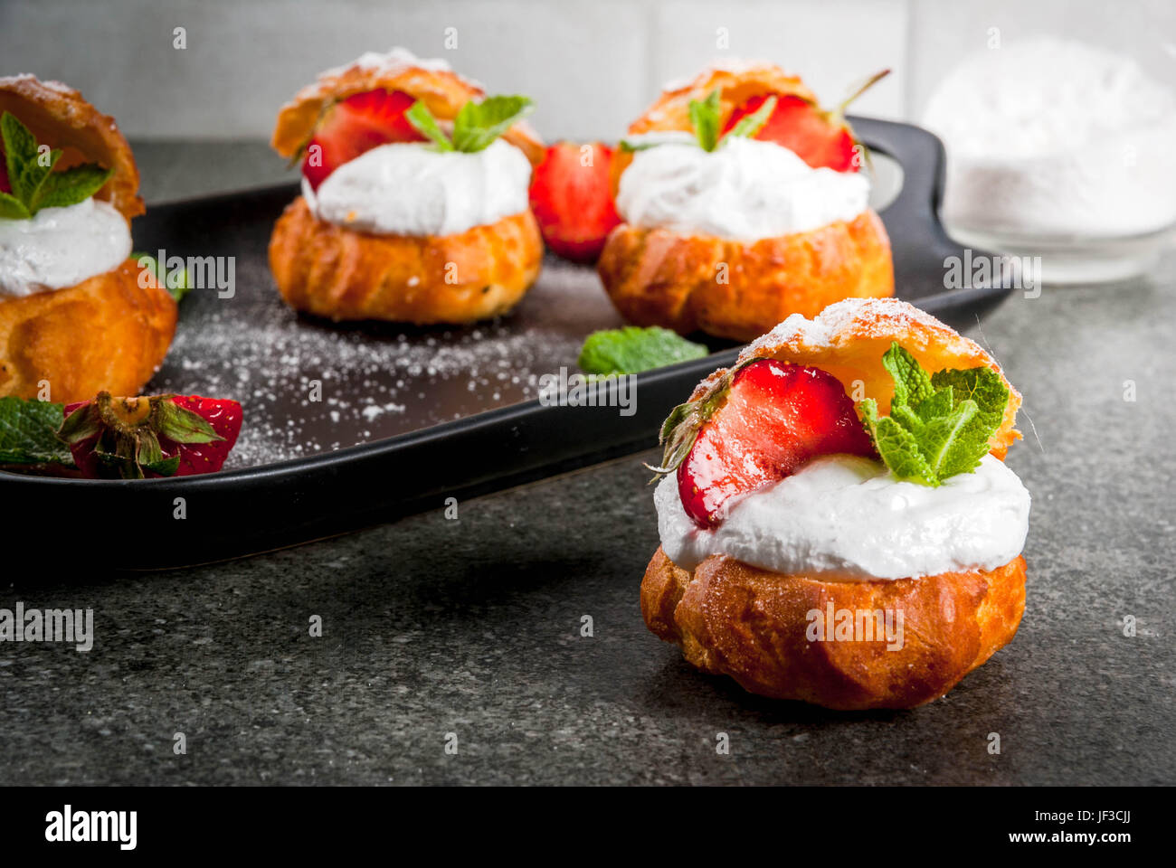 Summer desserts. Homemade baking. Cake profiteroles with whipped cream ...